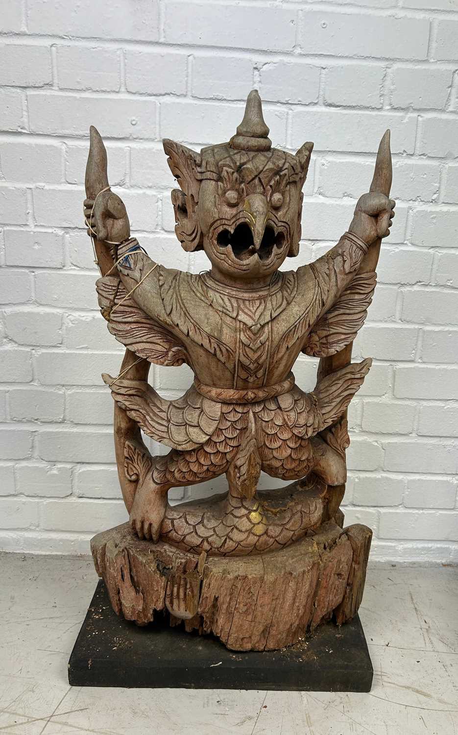 Lot 573 - A CARVED FIGURE OF GARUDA ON STAND, 85cm x