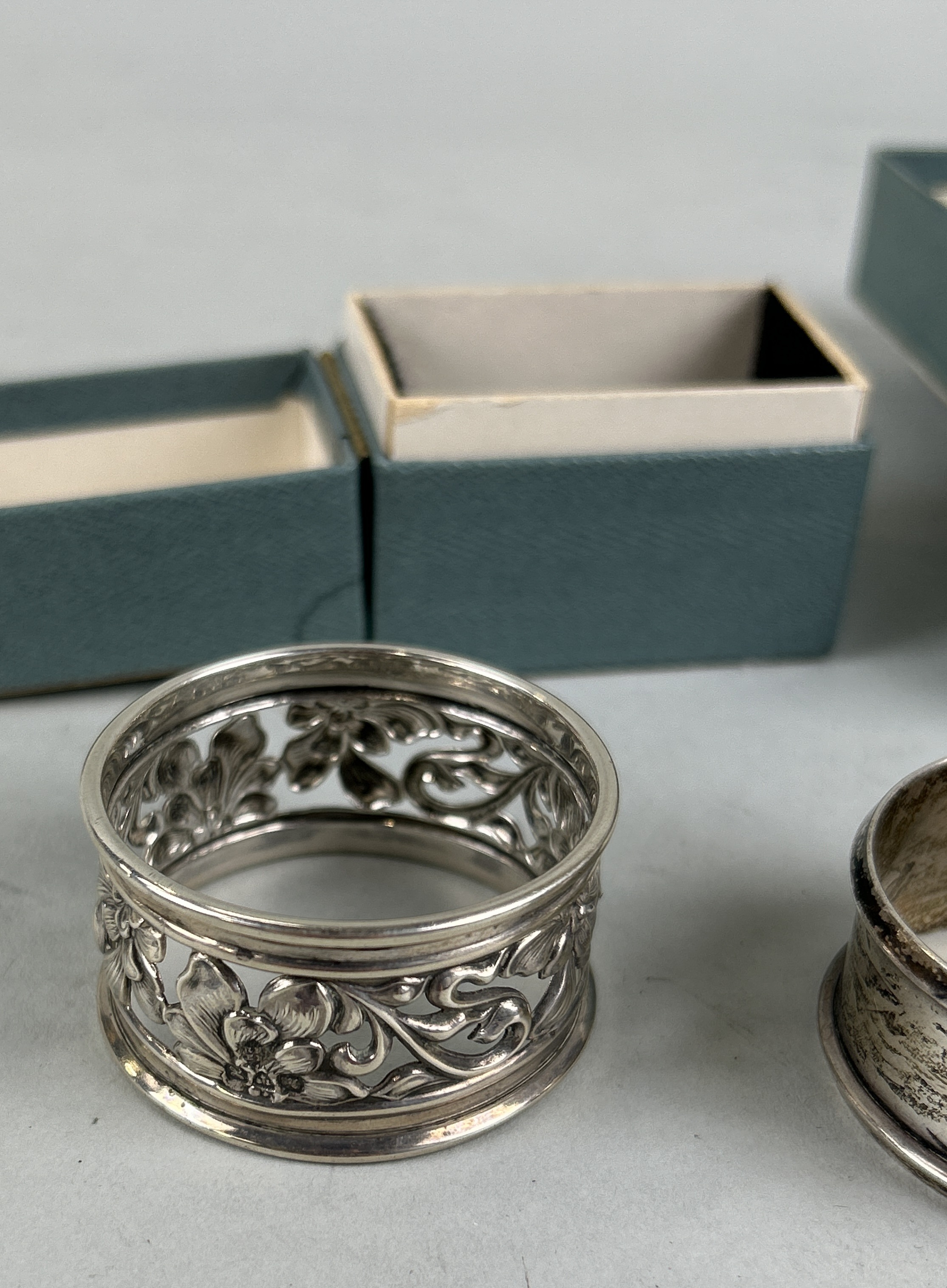 Lot 295 - FIVE SILVER NAPKIN RINGS THREE WITH BOXES