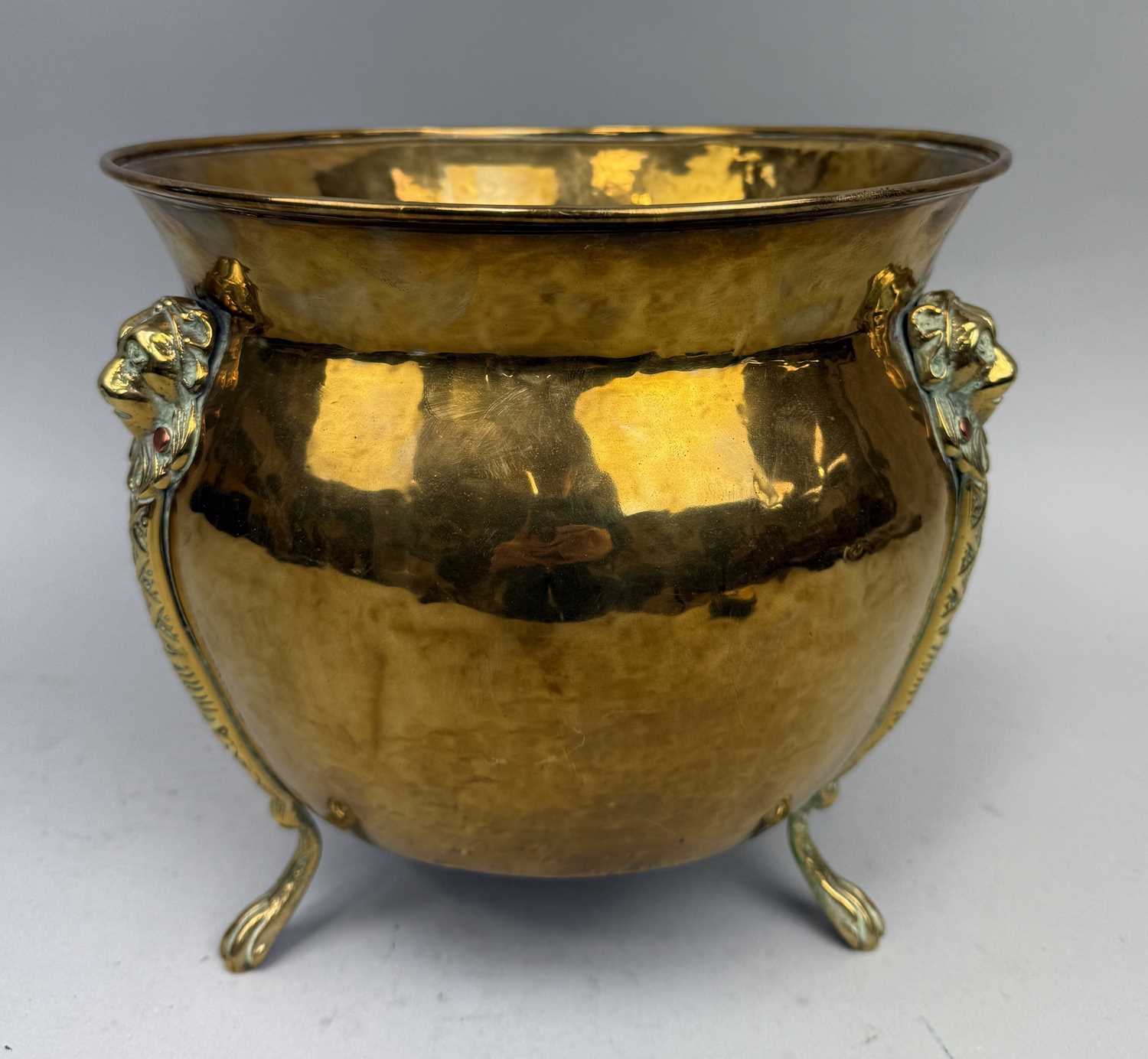 Lot 530 - A BRASS IRISH PLANTER WITH LIONS HEAD