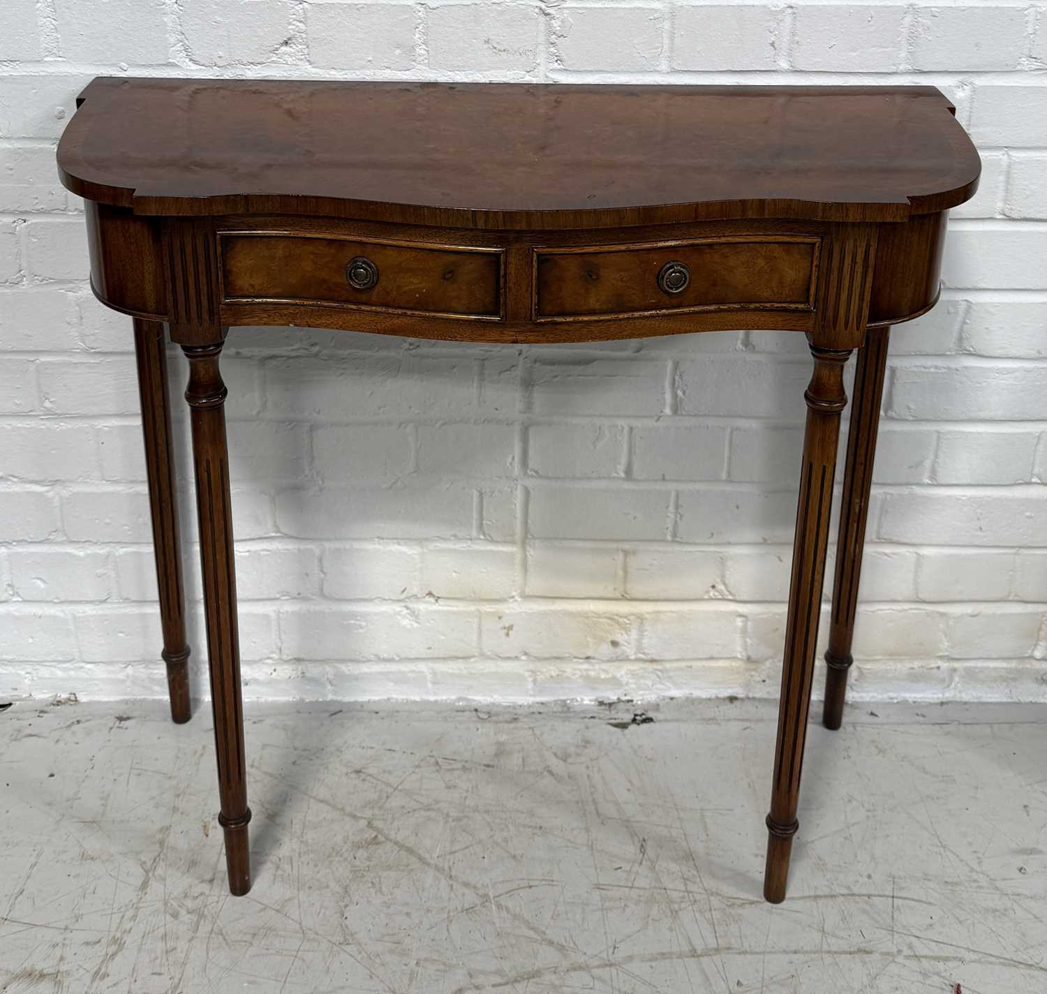 Lot 793 - A REPRODUCTION SERPENTINE CONSOLE TABLE