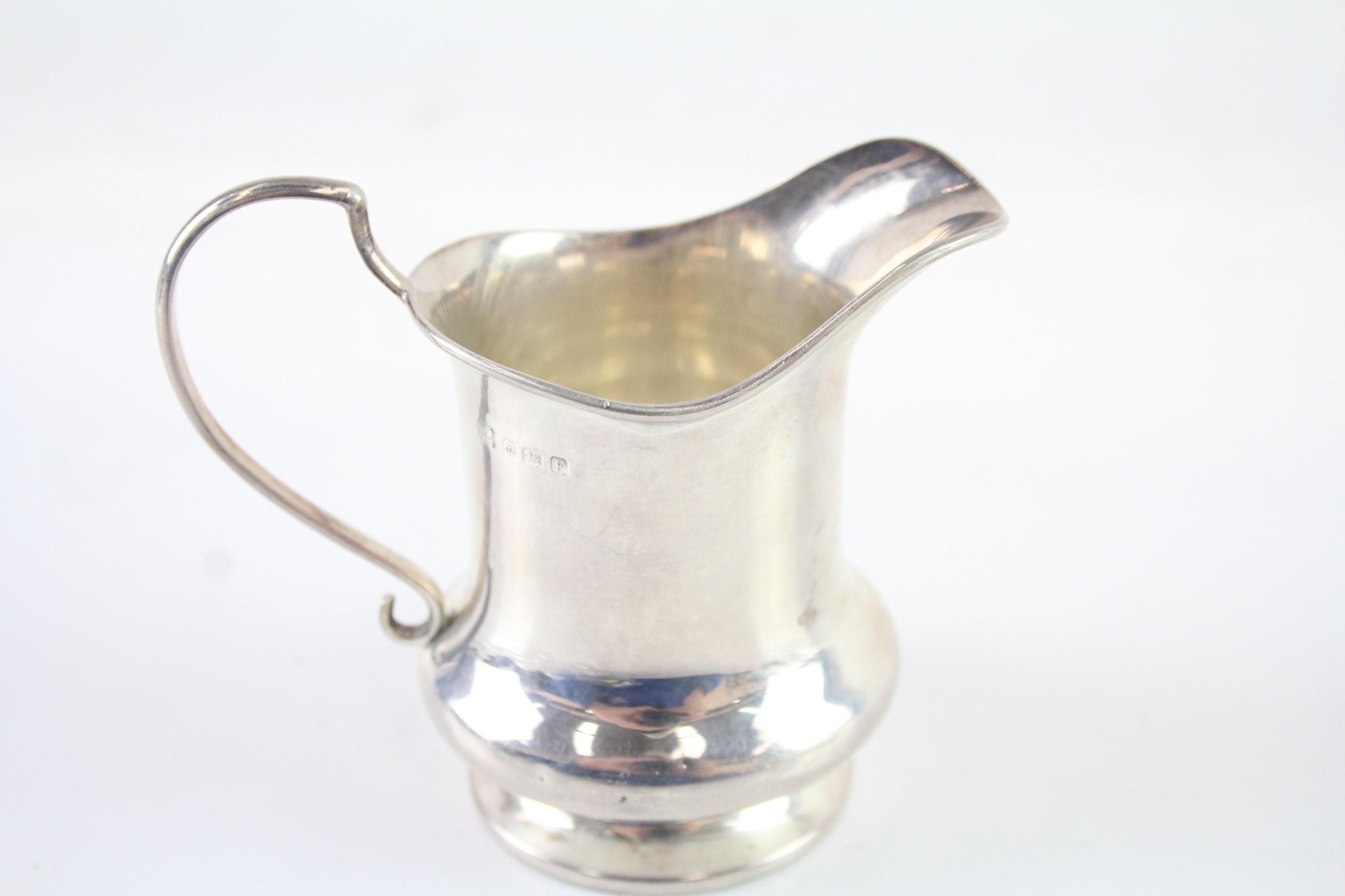 Lot 406 - A .925 STERLING SILVER CREAM JUG
