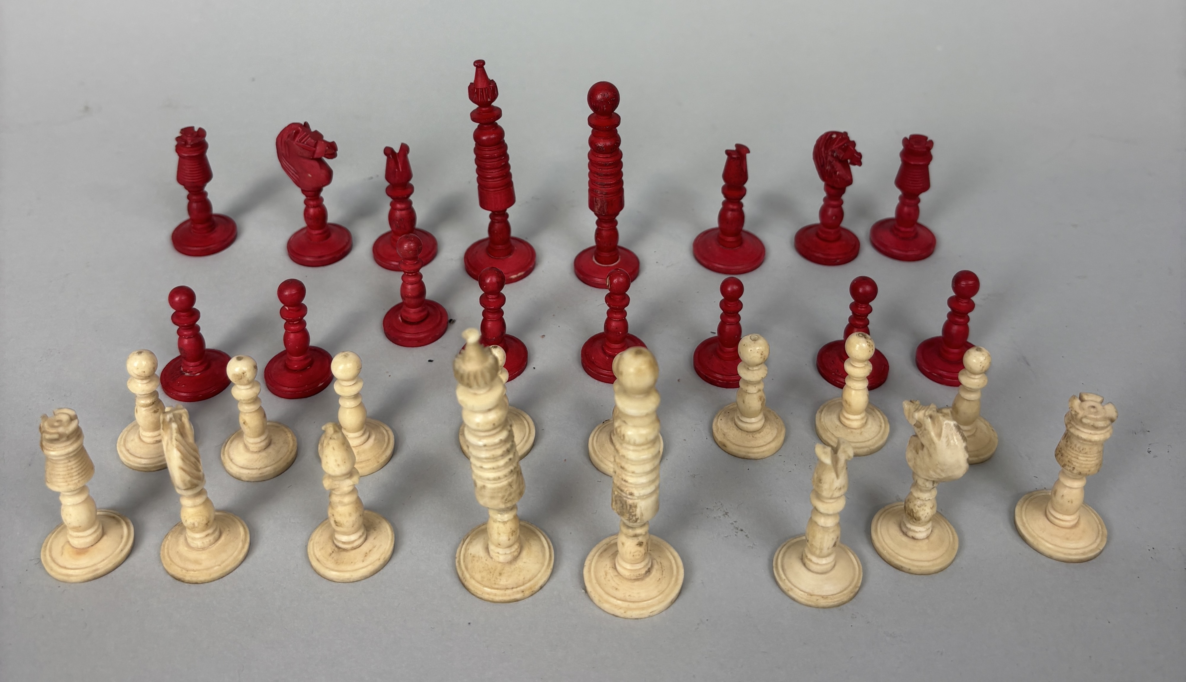 Lot 615 - A RED & WHITE BONE CHESS SET