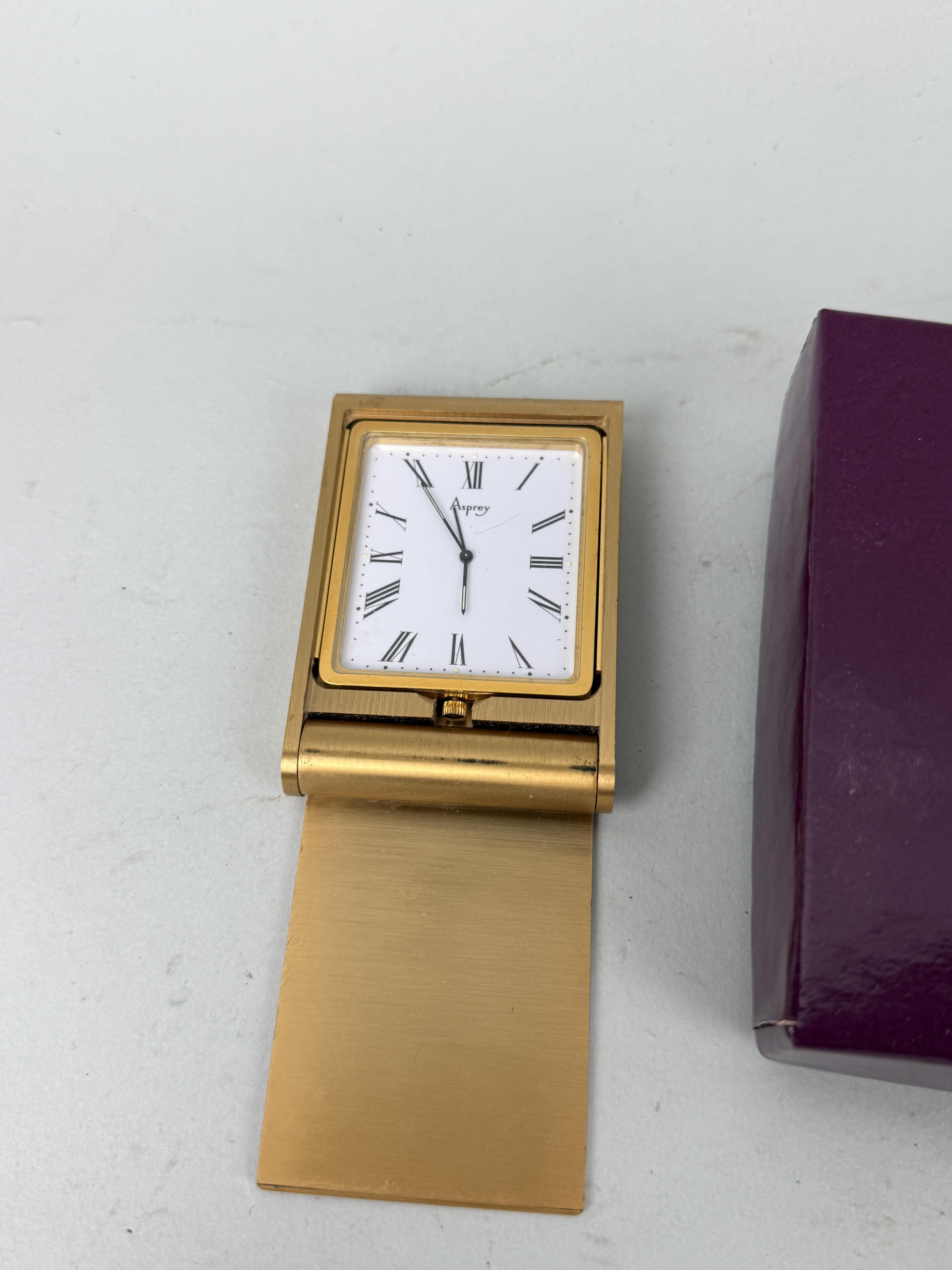 Lot 304 - AN ASPREY SMALL TRAVEL CLOCK